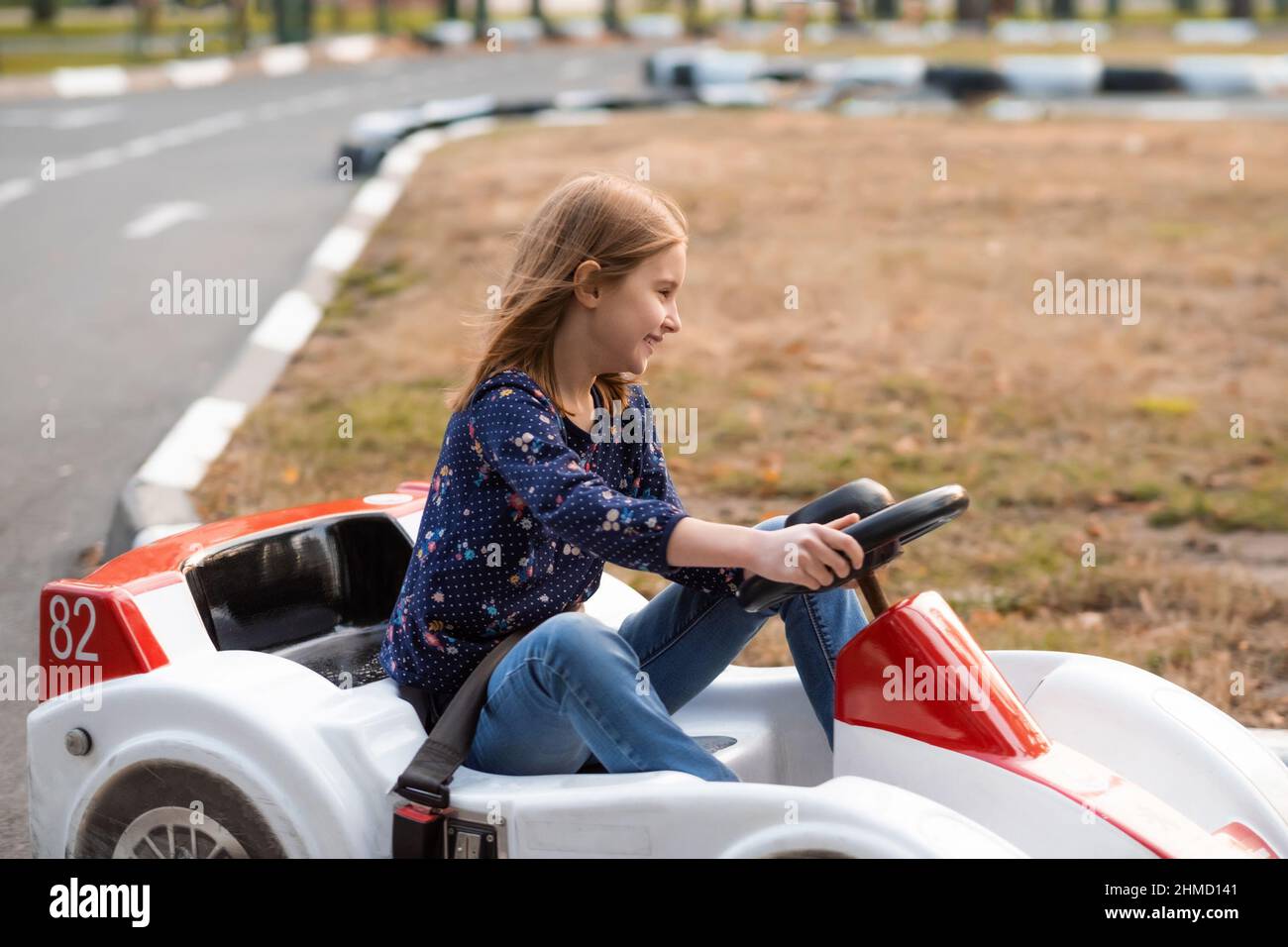 Cute girl playing driving car hi-res stock photography and images - Alamy