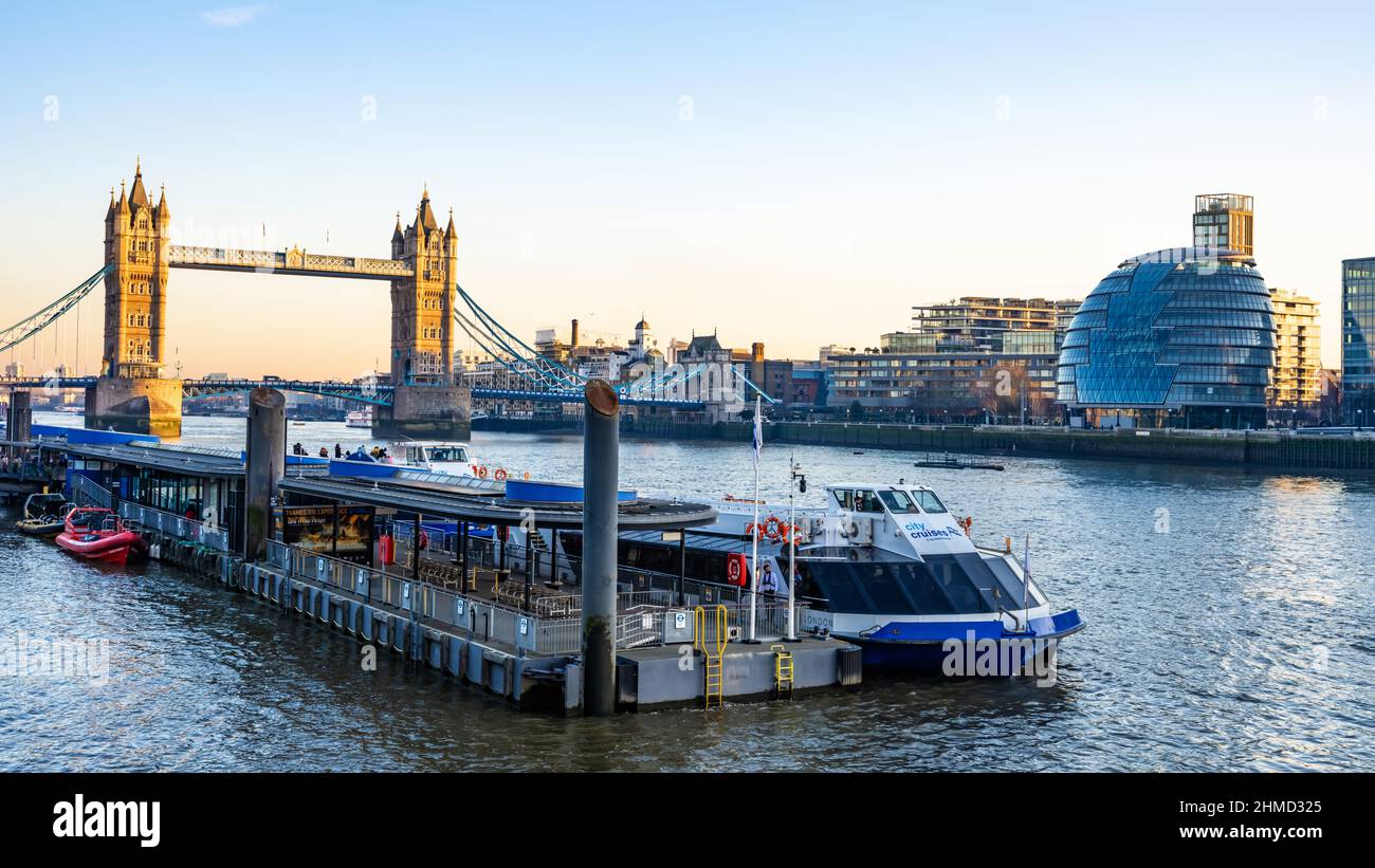 Sunset on Tower Bridge with City Hall. City Cruises boat Stock Photo ...