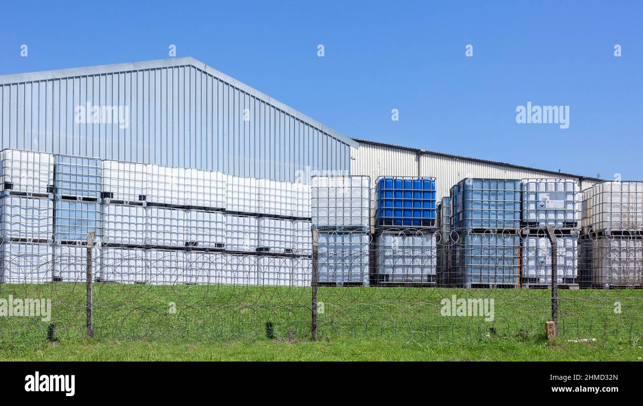 Industrial chemical metal caged holding plastic tanks for liquids ...