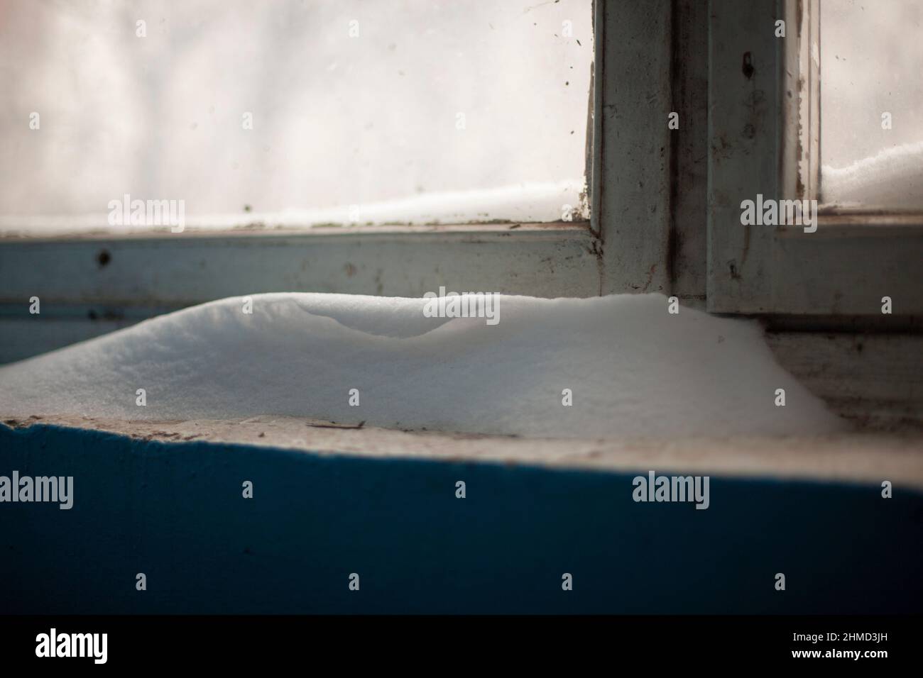 Snow on window. Cold weather. Frozen window. Old window frame. Entrance ...