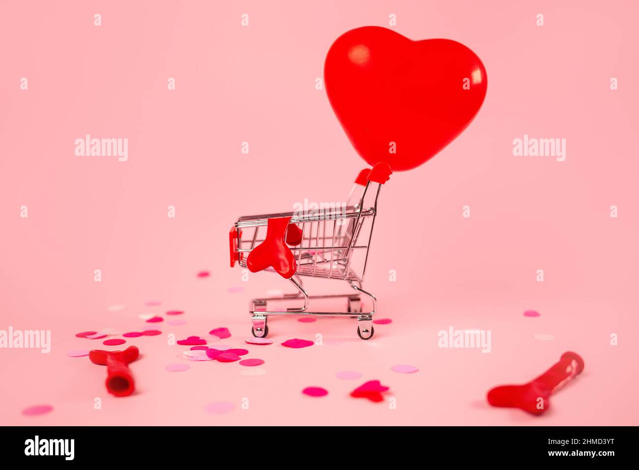 Valentine's day. Mini shopping cart with an inflated balloon in the ...