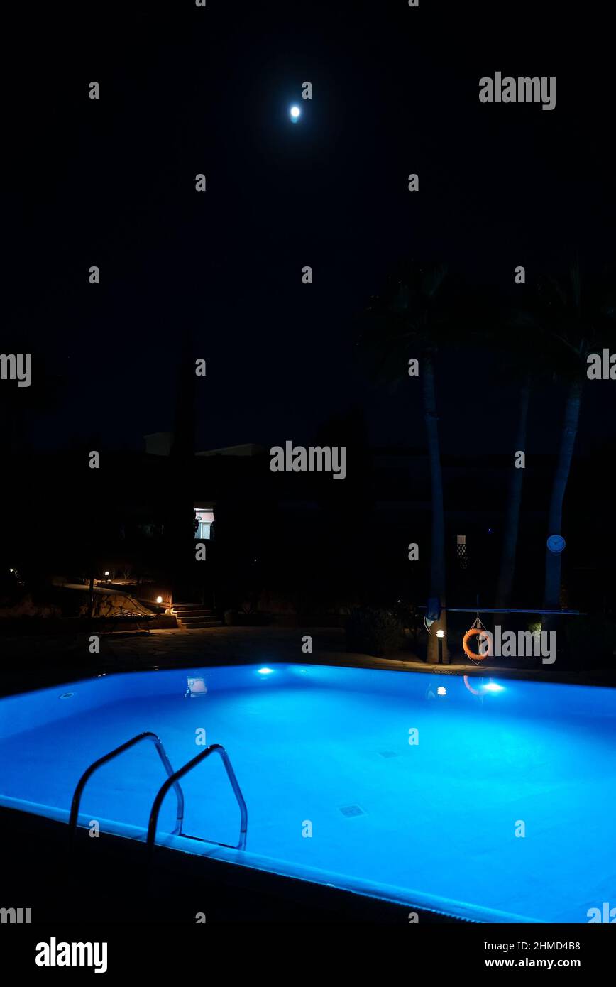 Modern backyard water pool at night Stock Photo - Alamy
