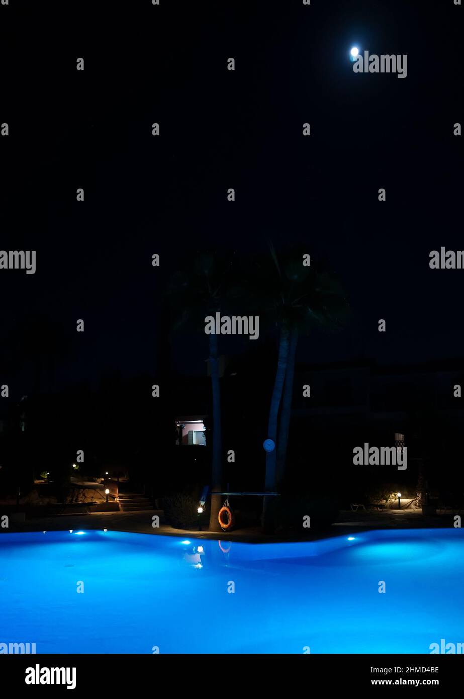 Modern backyard water pool at night Stock Photo - Alamy