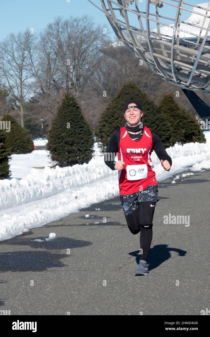 A runner wearing an FDNY tank top finishing the NYC Winter Park Tour 4 ...