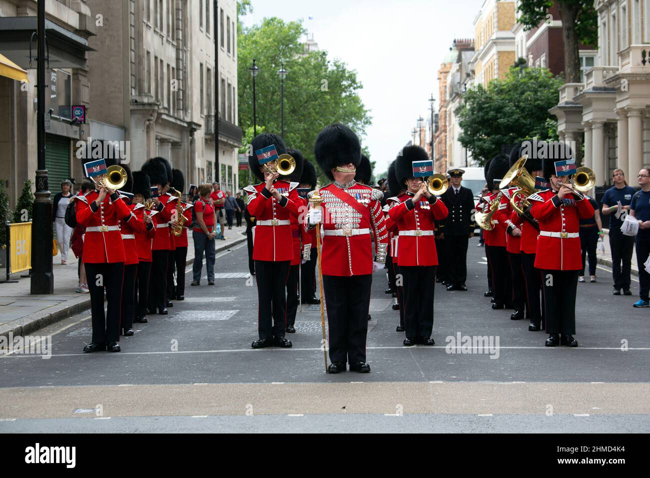A brass band in red uniform performs in the Pride in London festival in ...