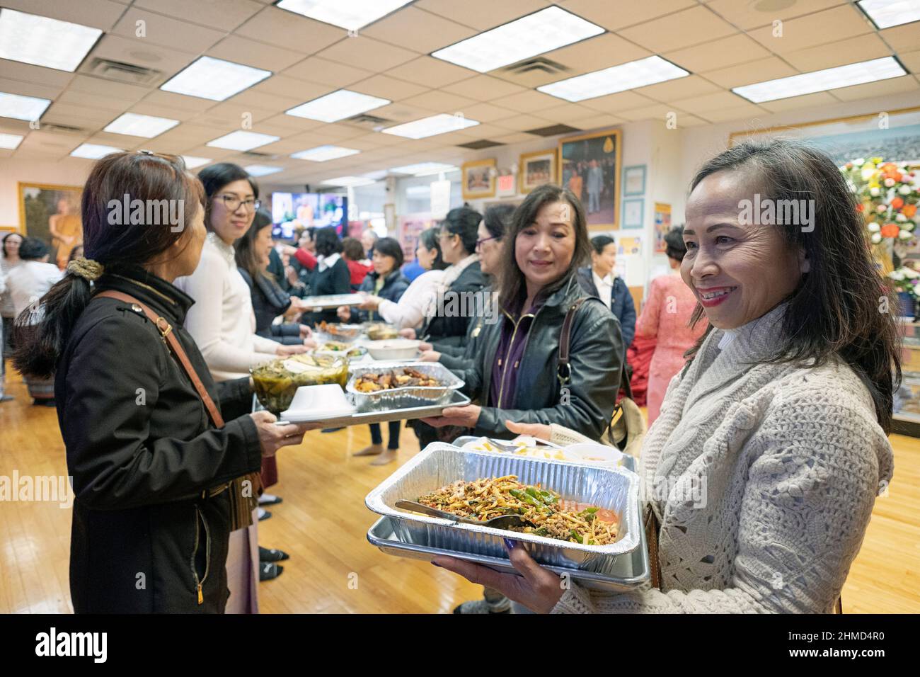 After a prayer service in a Buddhist temple, the congregants perform ...