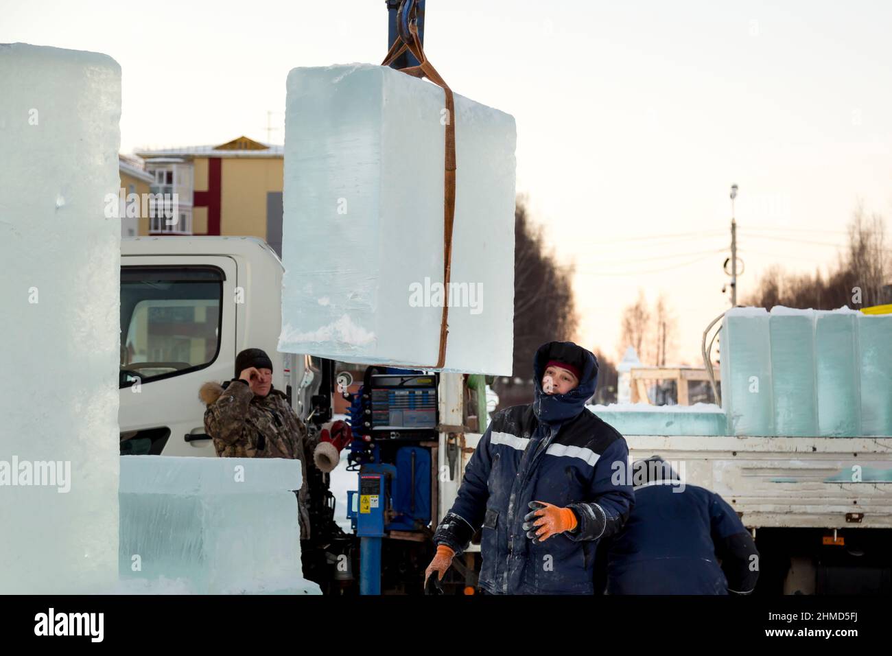 Two assembly workers unload ice plates from the body of a car Stock ...