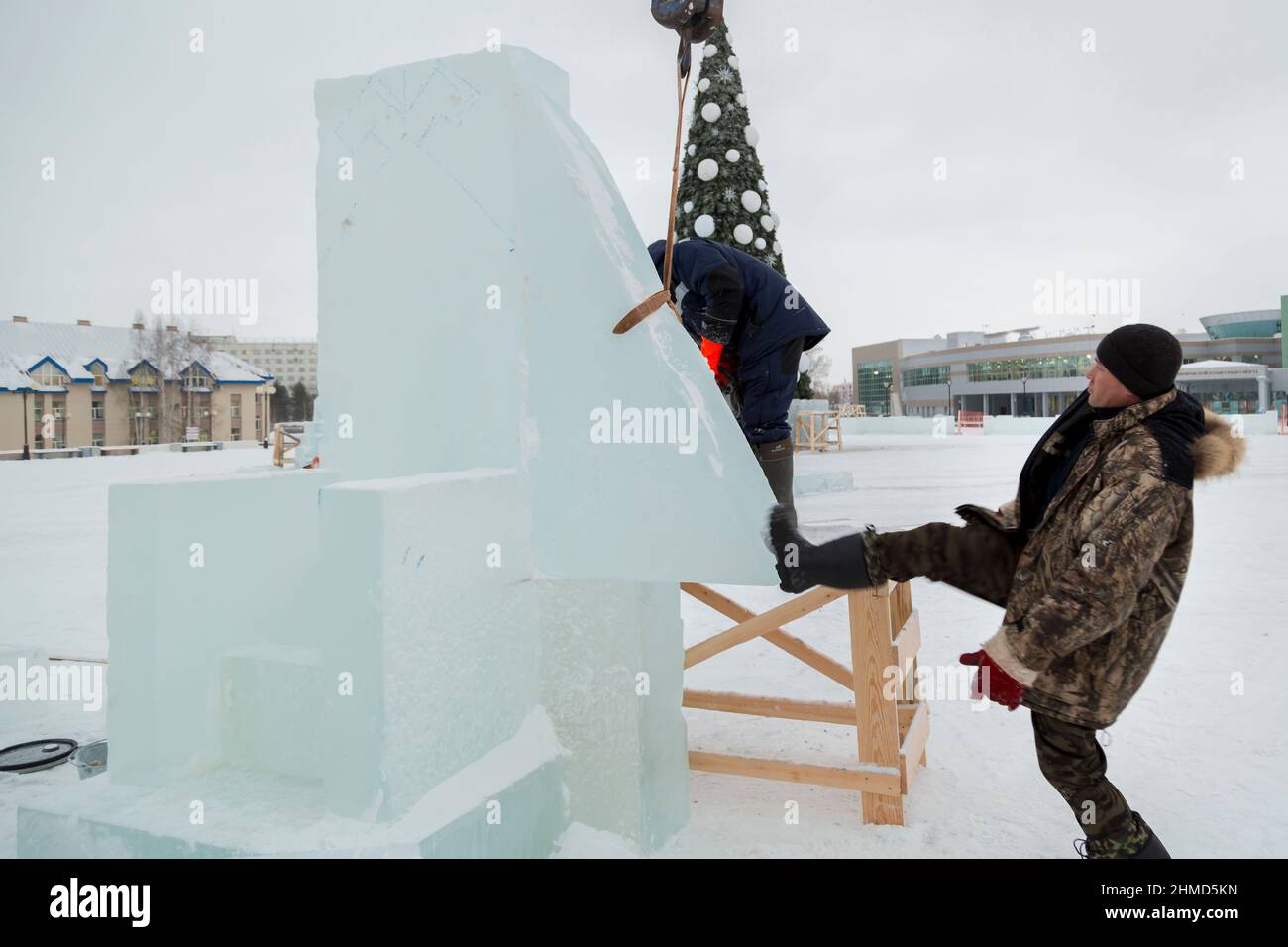 Installer in winter gear at the installation of ice panels Stock Photo ...
