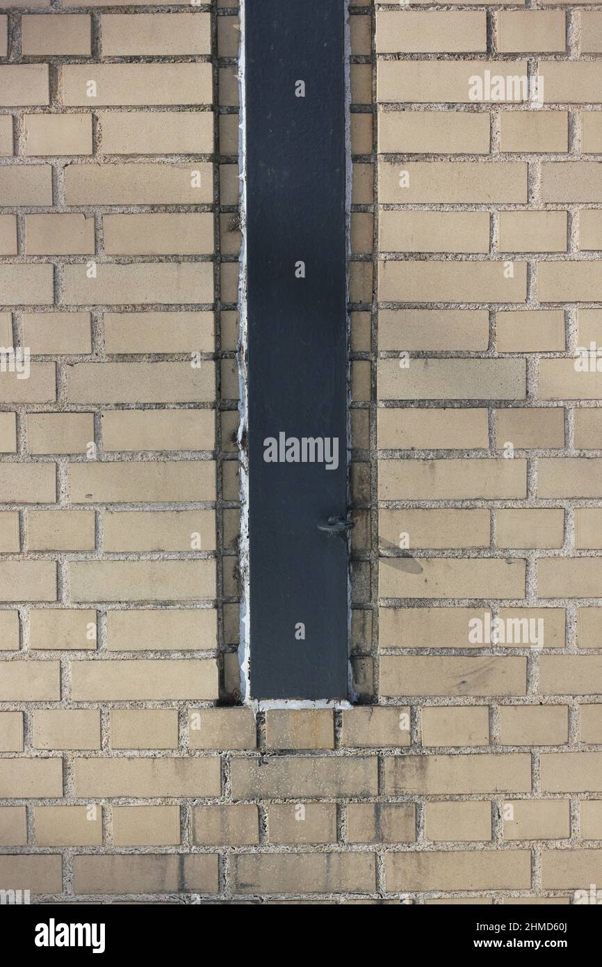 Simplistic view of a modern steel mullion embedded in a brick wall ...
