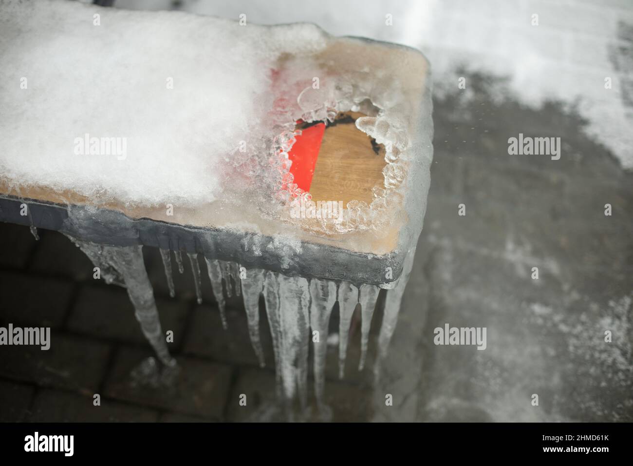 Icy seat. Details of freezing rain Ice outside. Aftermath of storm ...