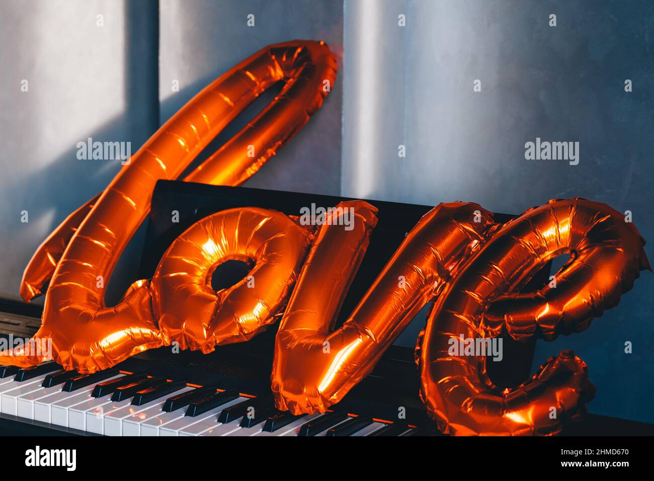 balloon in shape of word love on piano keys. copy space. Greeting card ...