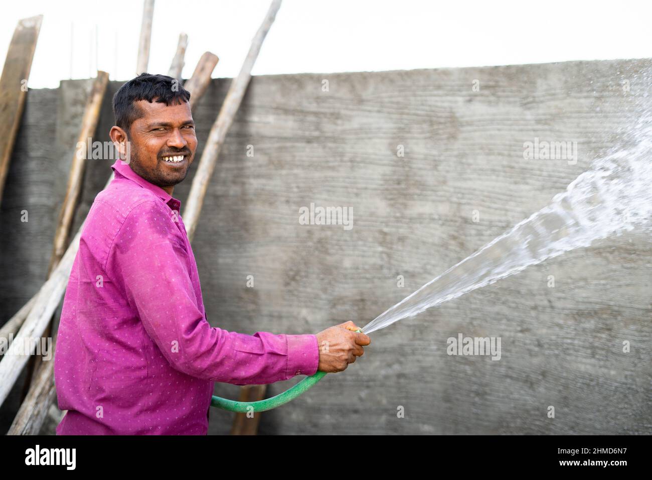happy Construction labour curing brick cement wall by using water to ...