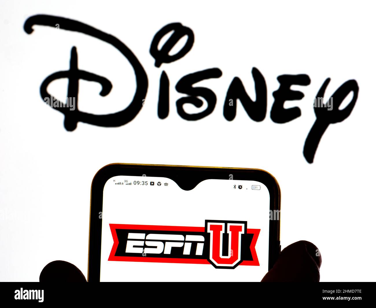 In this photo illustration, the ESPN U logo is displayed on a smartphone screen with the Disney ...