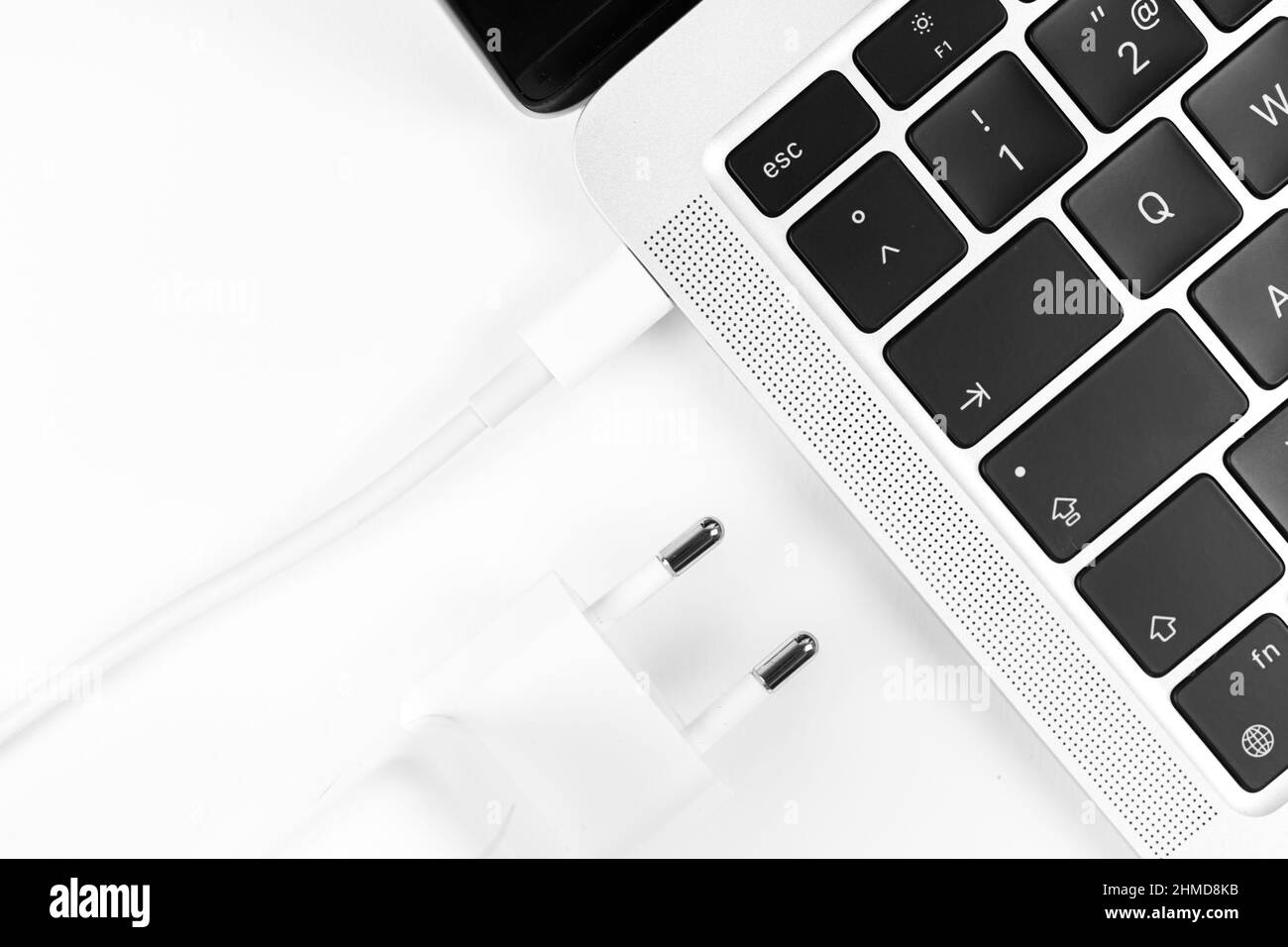 Charging battery laptop. Modern USB C port for fast charge. White cable ...