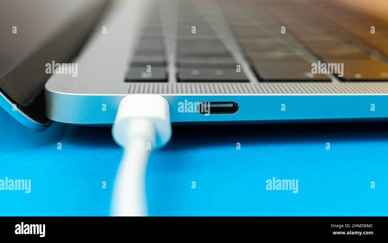 Charging laptop with modern USB Type C port. Laptop low battery concept ...