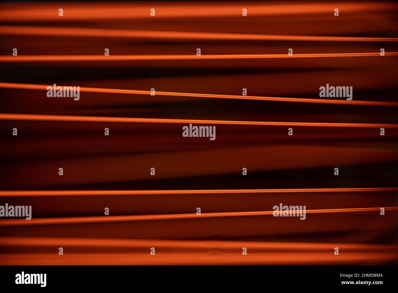 Bright dark red-orange background in fiery and fiery stripes with an ...