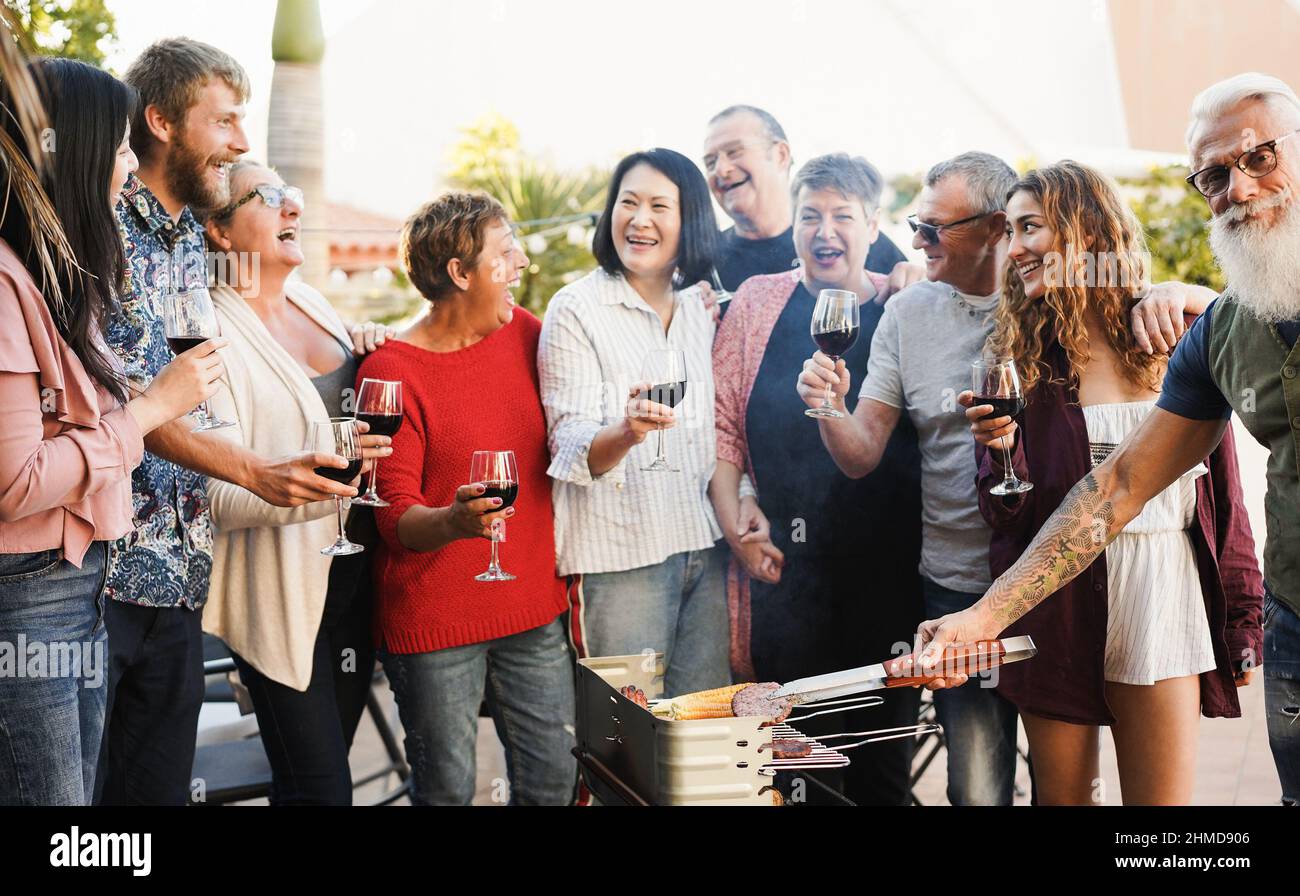 Multi generational friends having fun at barbecue dinner outdoor ...