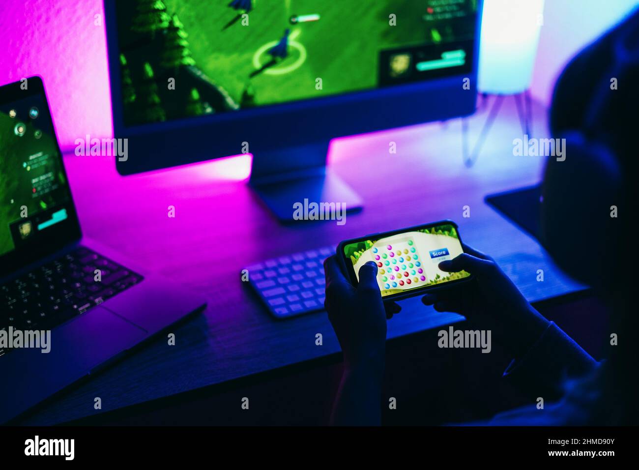 Girl gamer playing video game online on mobile phone - Focus on left ...