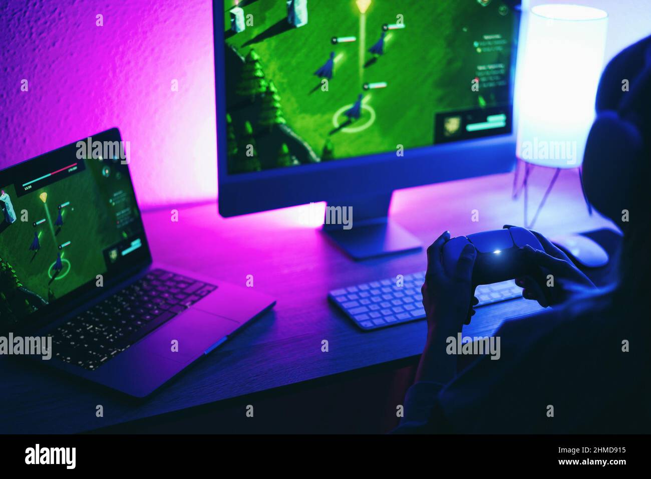 Gamer playing strategy game online using wireless controller - Focus on ...