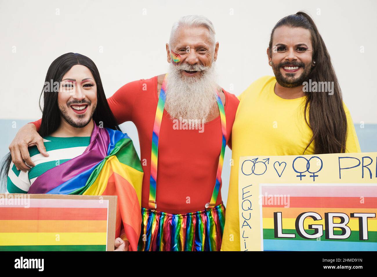 Gay people having fun at pride parade with LGBT banner outdoors - Focus ...
