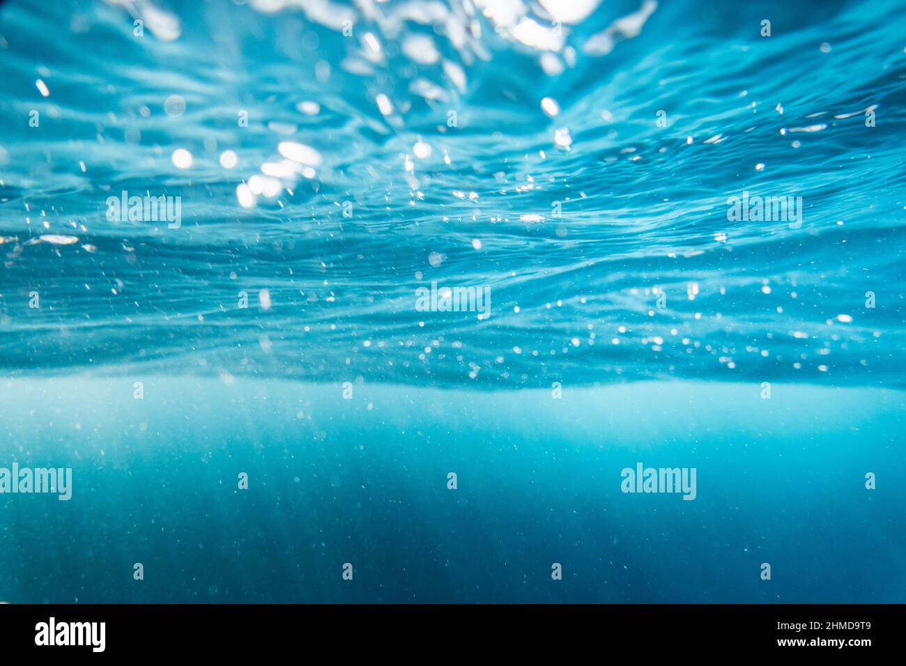 Sunlight in ocean water shining through surface Stock Photo - Alamy