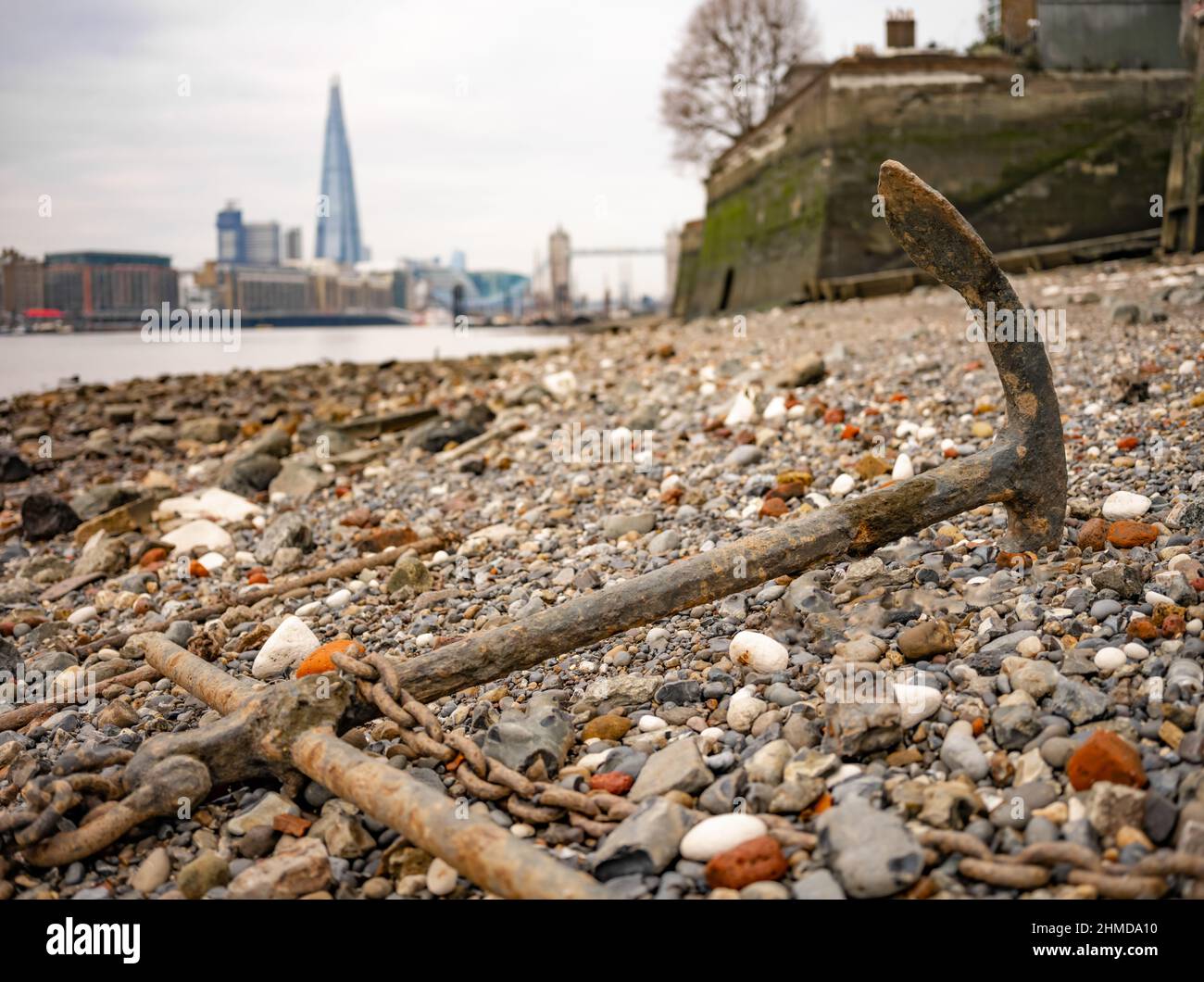Old anchor in the Thames shale, with Tower Bridge and the Shard Stock ...