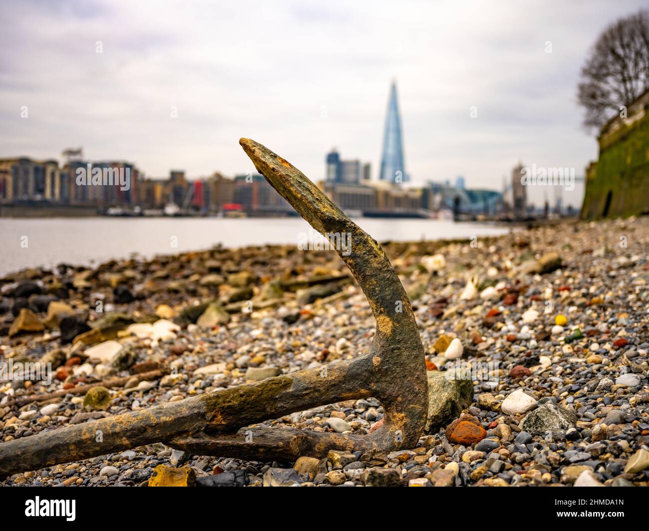 Old anchor in the Thames shale, with Tower Bridge and the Shard Stock ...