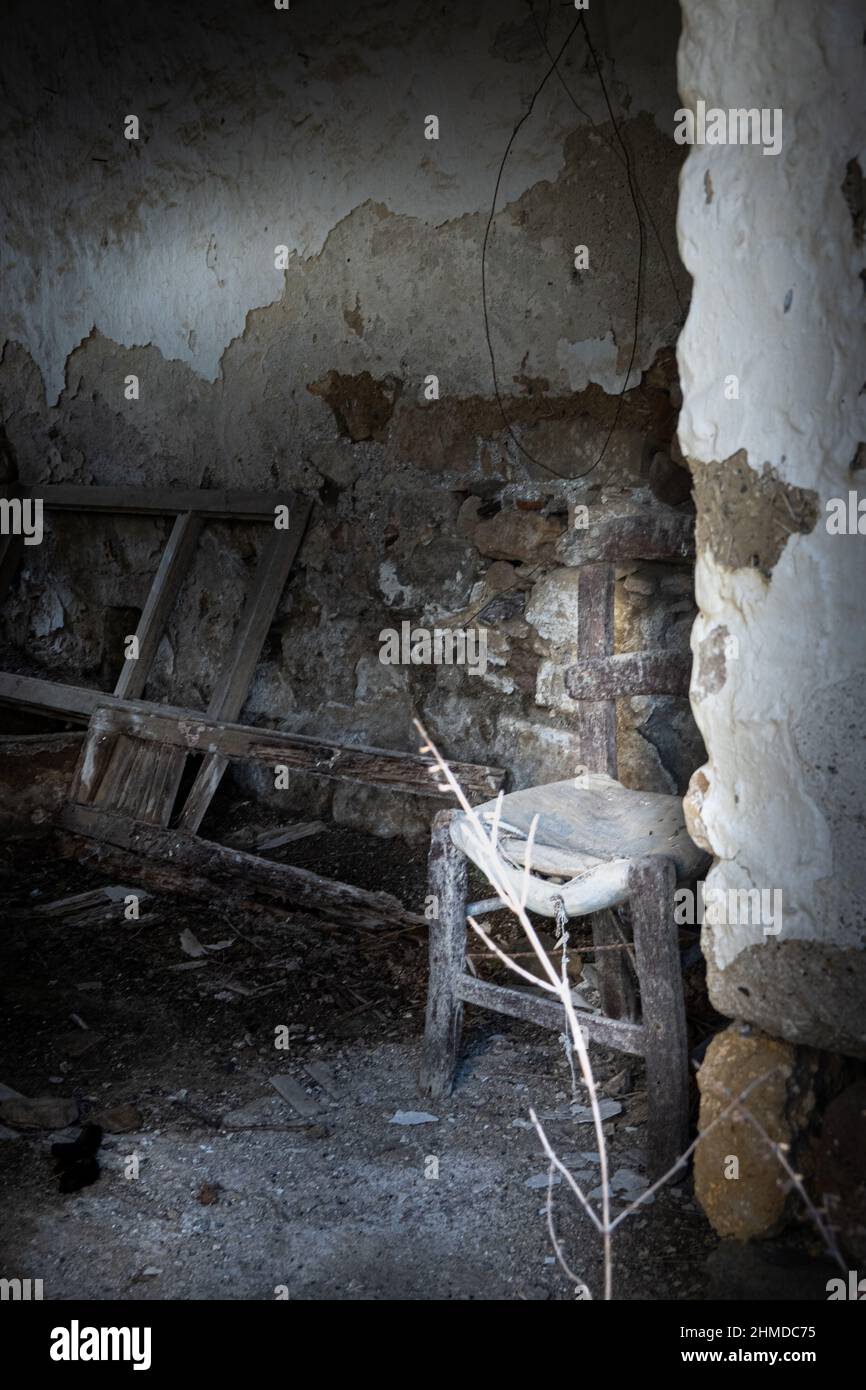 Abandoned old broken chair beside wall in house Stock Photo - Alamy