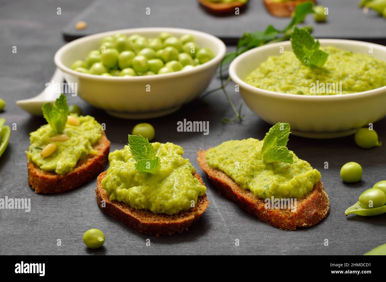 Vegeterian food. Sandwiches with green pea puree. Green pea puree in ...