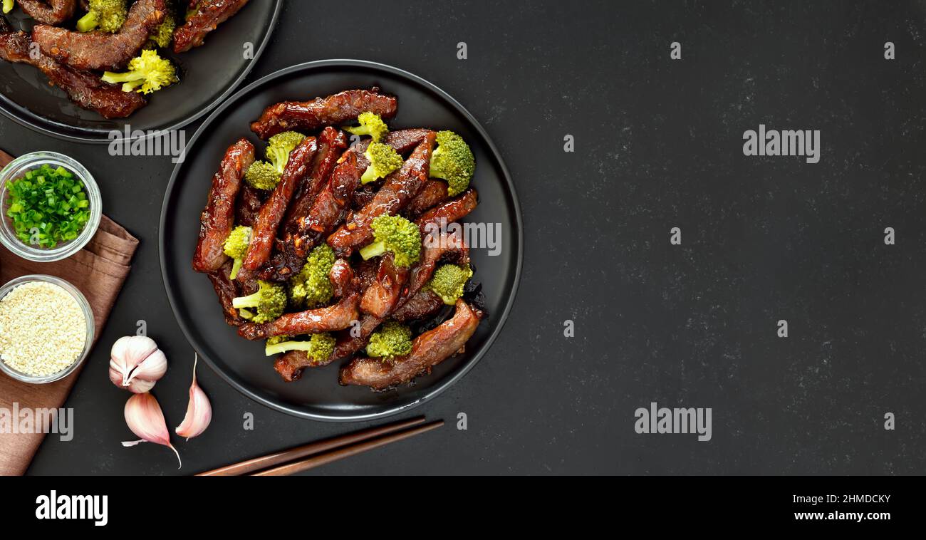 Beef stir-fry with broccoli over dark background with copy space. Top ...