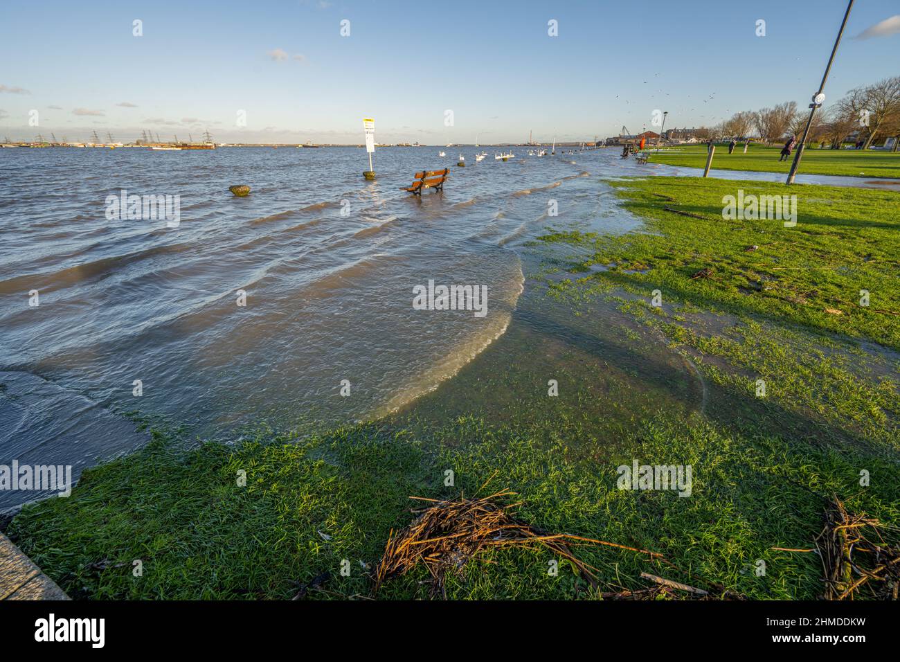 High water at spring tide overflowing the sea wall on the banks of the ...