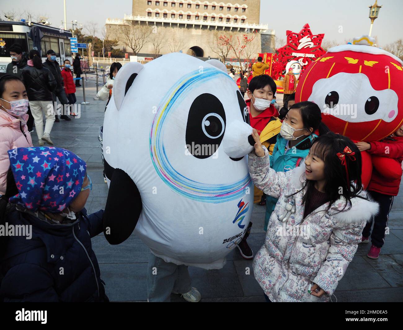 BEIJING, CHINA - FEBRUARY 9, 2022 - Tourists pose for photos with Bing Dwen Dwen and Xue Rong ...