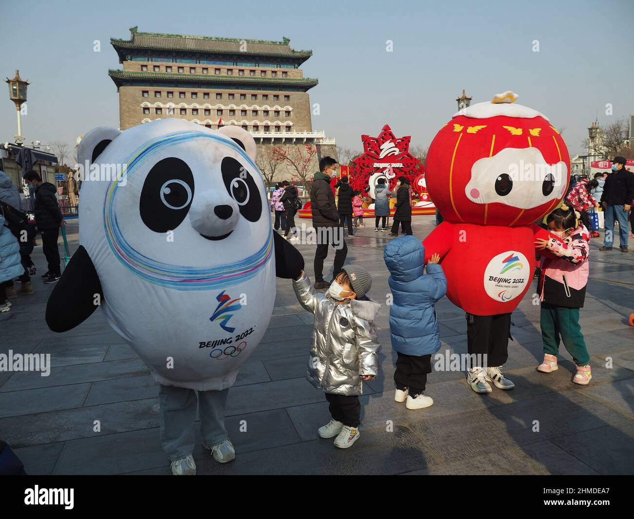 BEIJING, CHINA - FEBRUARY 9, 2022 - Tourists pose for photos with Bing Dwen Dwen and Xue Rong ...