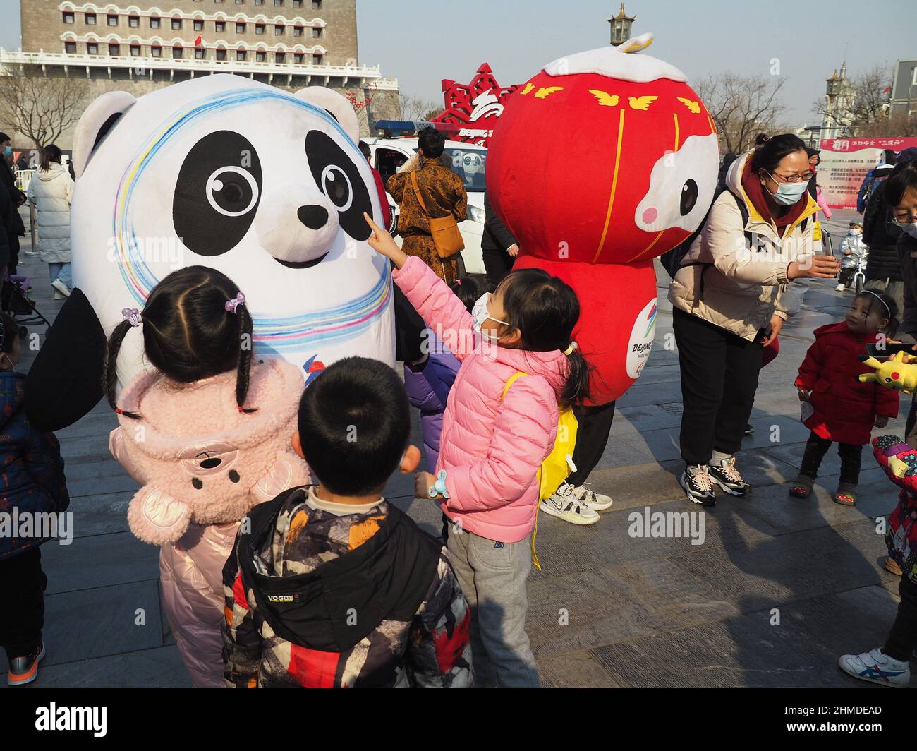 BEIJING, CHINA - FEBRUARY 9, 2022 - Tourists pose for photos with Bing Dwen Dwen and Xue Rong ...