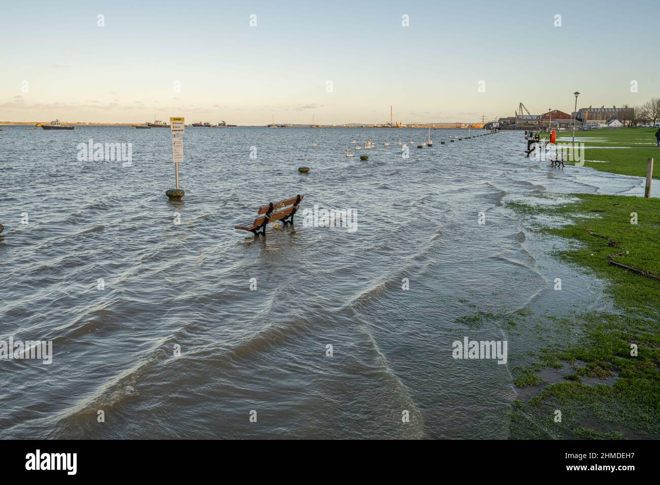 High water at spring tide overflowing the sea wall on the banks of the ...