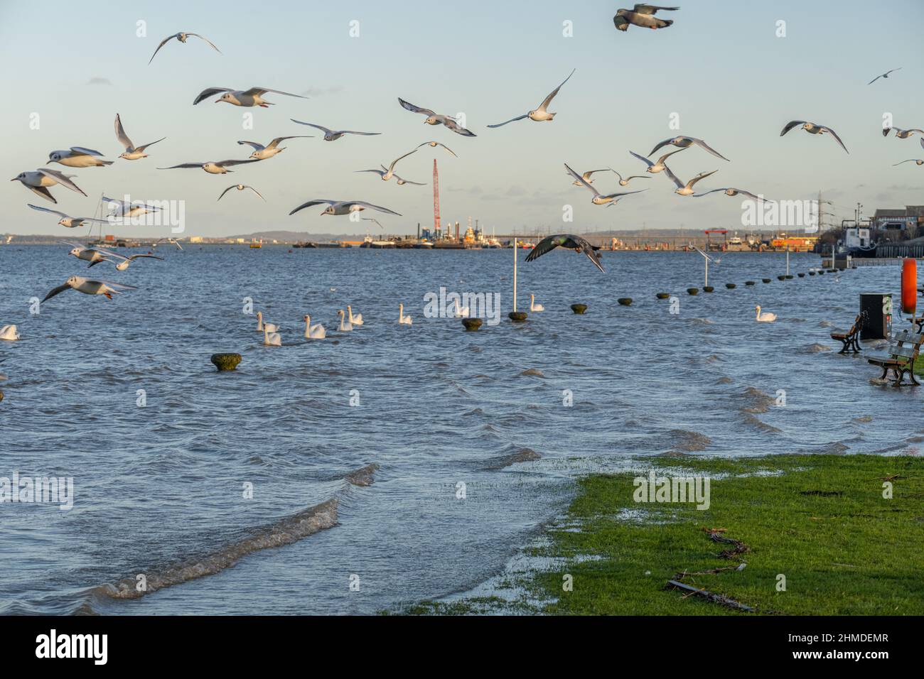 High water at spring tide overflowing the sea wall on the banks of the ...