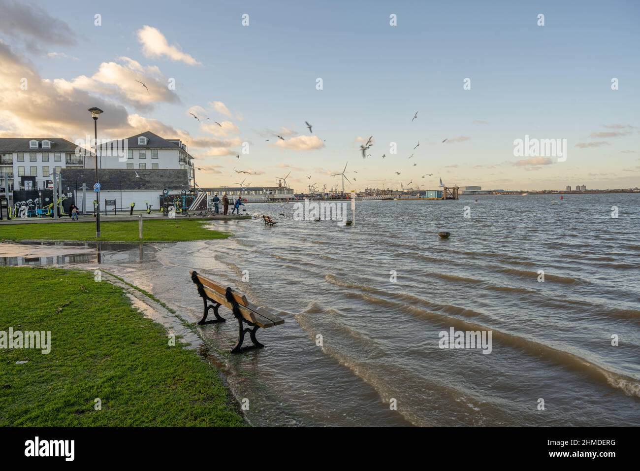High water at spring tide overflowing the sea wall on the banks of the ...