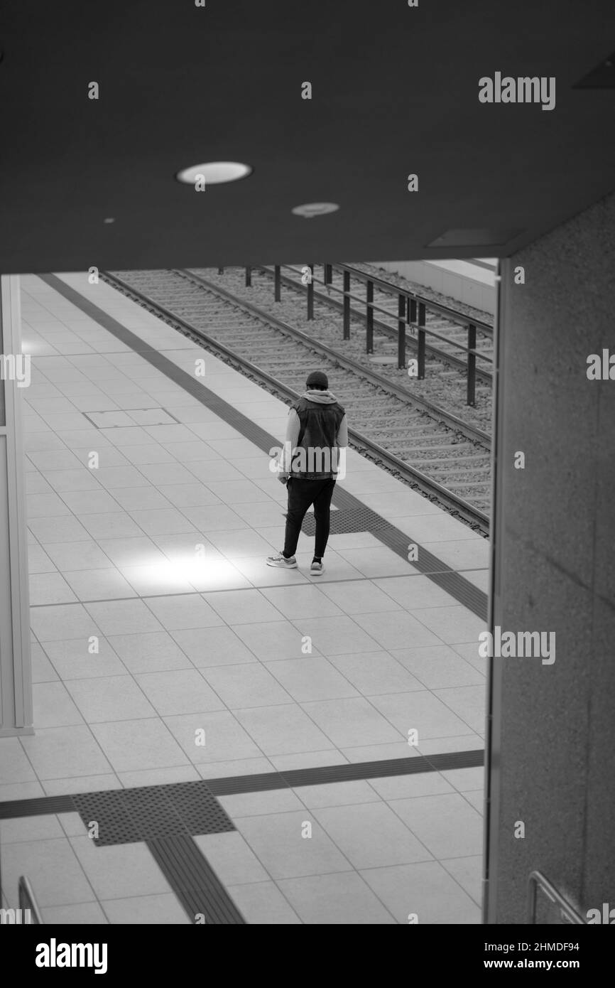 man in the subway waiting alone Stock Photo - Alamy