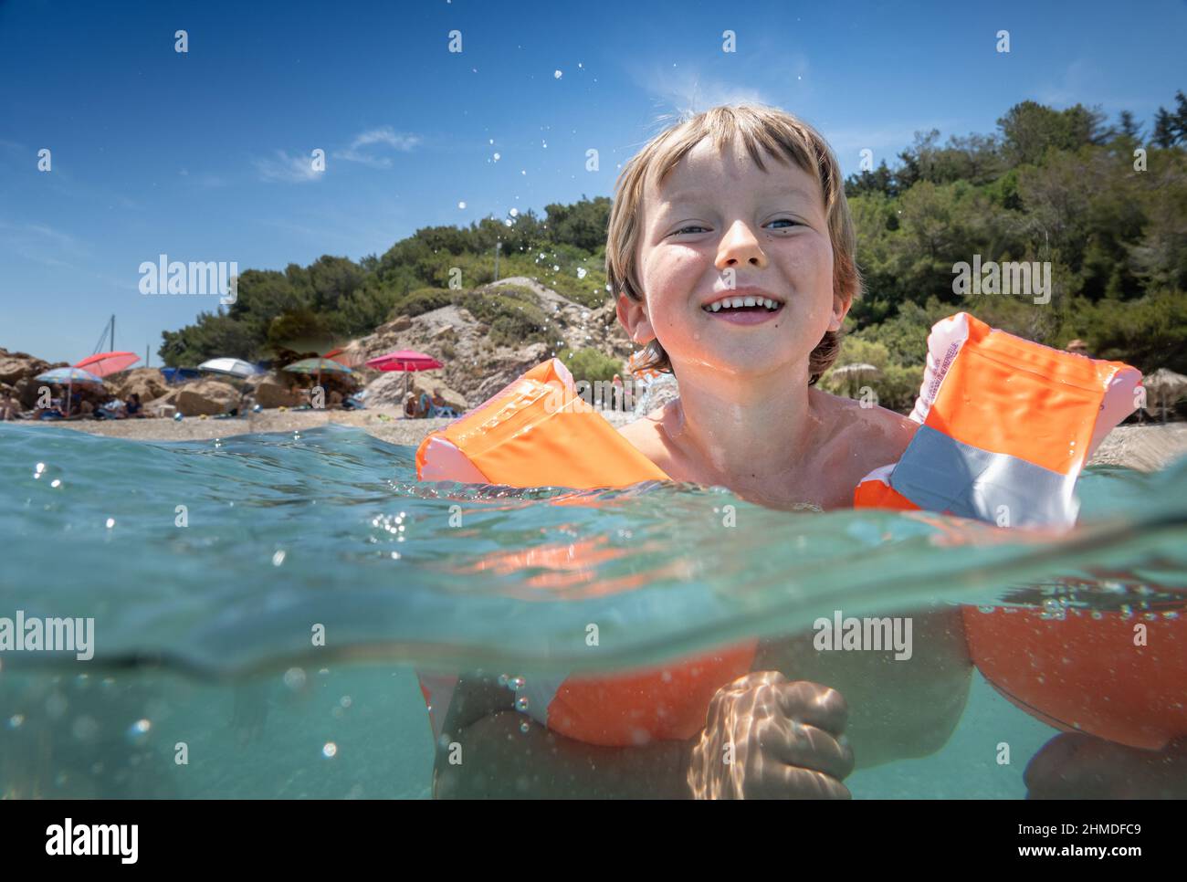 Cheerful boy learning to swim in sea Stock Photo - Alamy