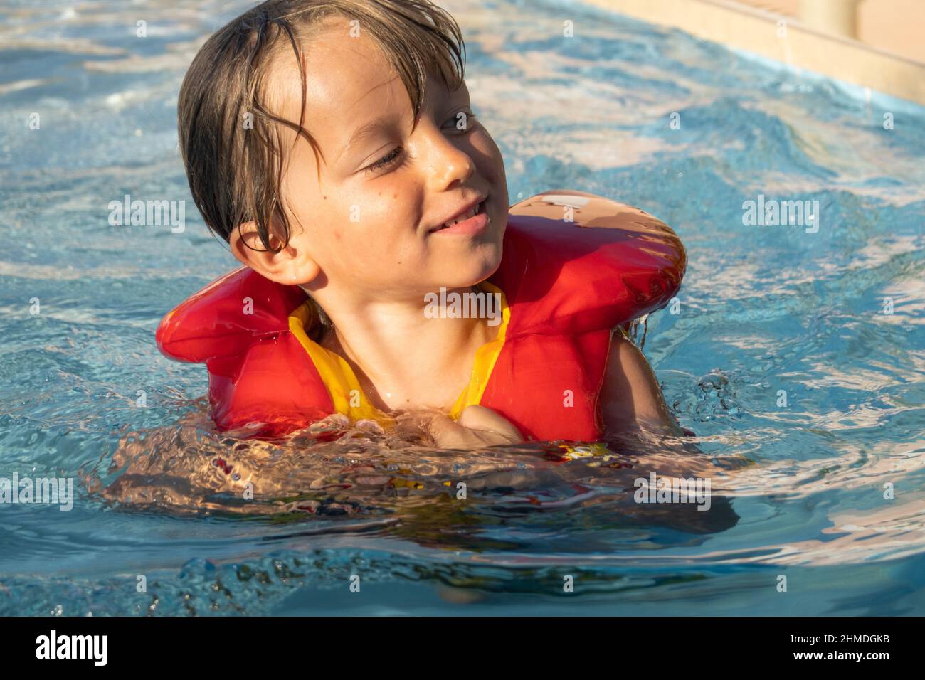 Boy with inflatable float swimming in pool Stock Photo - Alamy