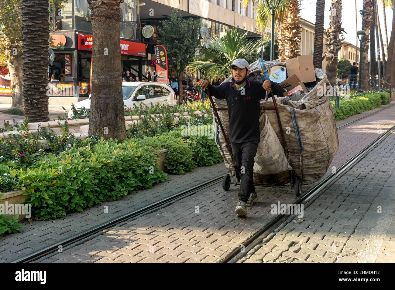 Antalya, Turkey - November 15, 2021: garbageman with a huge garbage bag ...