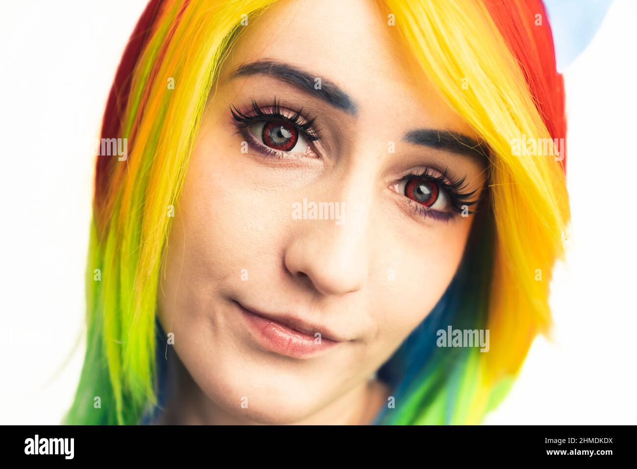 Red-coloured eyes with long dark lashes slowly looking into the camera ...