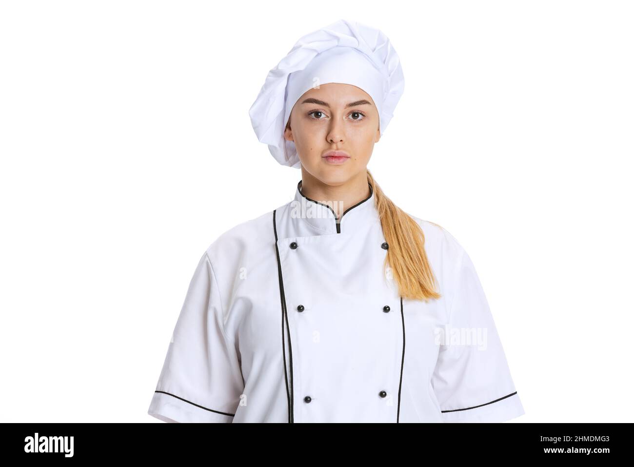 Young woman, lady-cook, chef in white uniform posing isolated on white ...