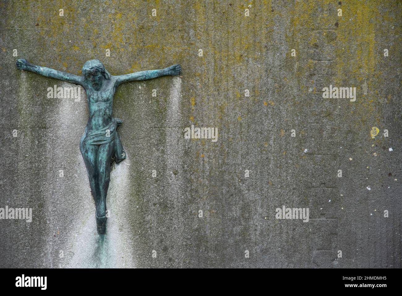Very old bronze statue patinated by the years on a weathered concrete ...