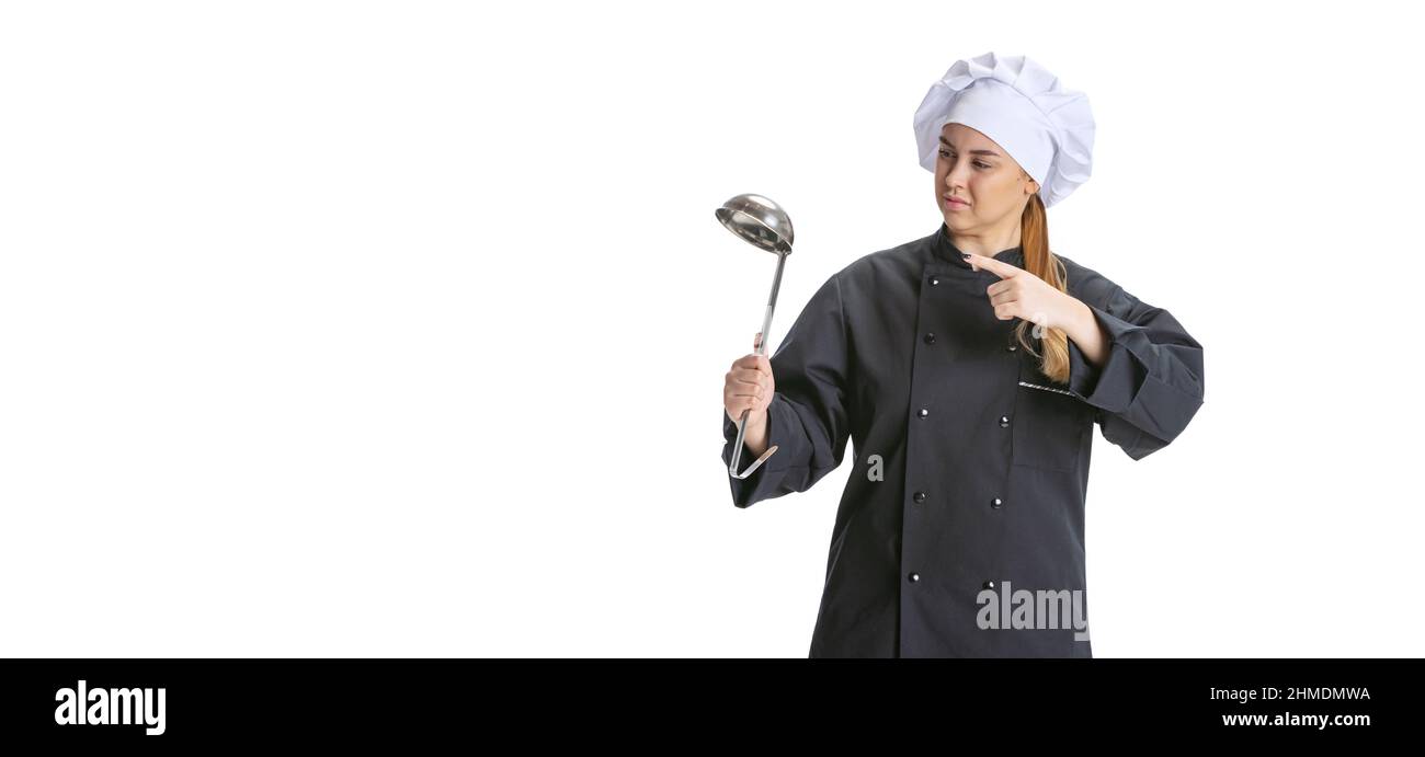 Happy beautiful young woman, lady-cook, chef in black uniform isolated ...
