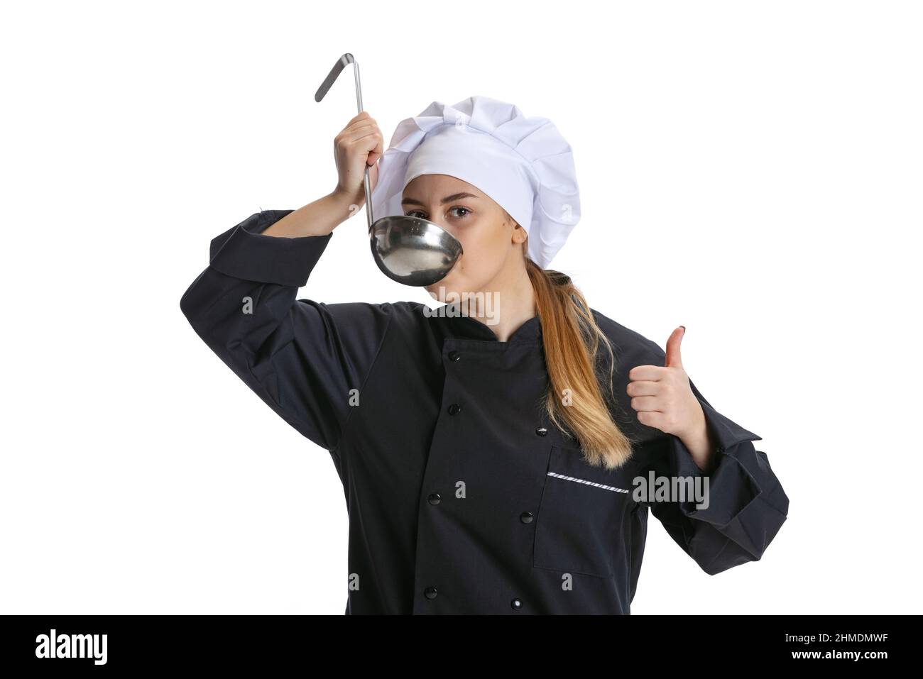 Happy beautiful young woman, lady-cook, chef in black uniform isolated ...