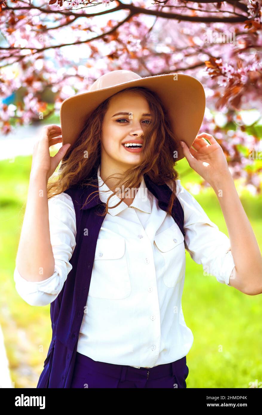 Outdoor portrait of young beautiful fashionable lady posing near ...