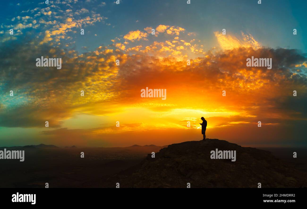 Flying a drone at sunset over the volcano from the mountain top in ...