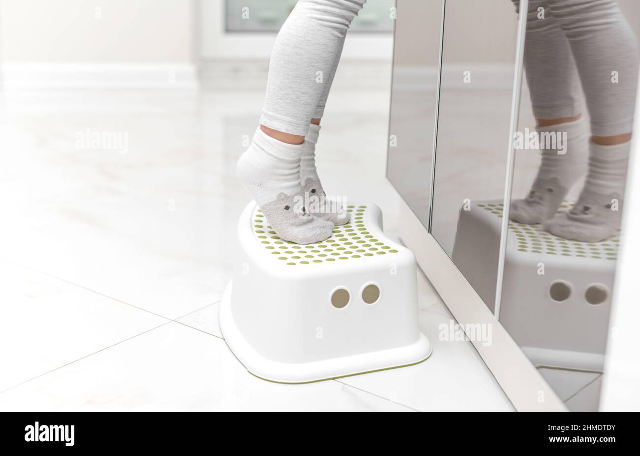 Small feet stand on a stand for children Stock Photo - Alamy