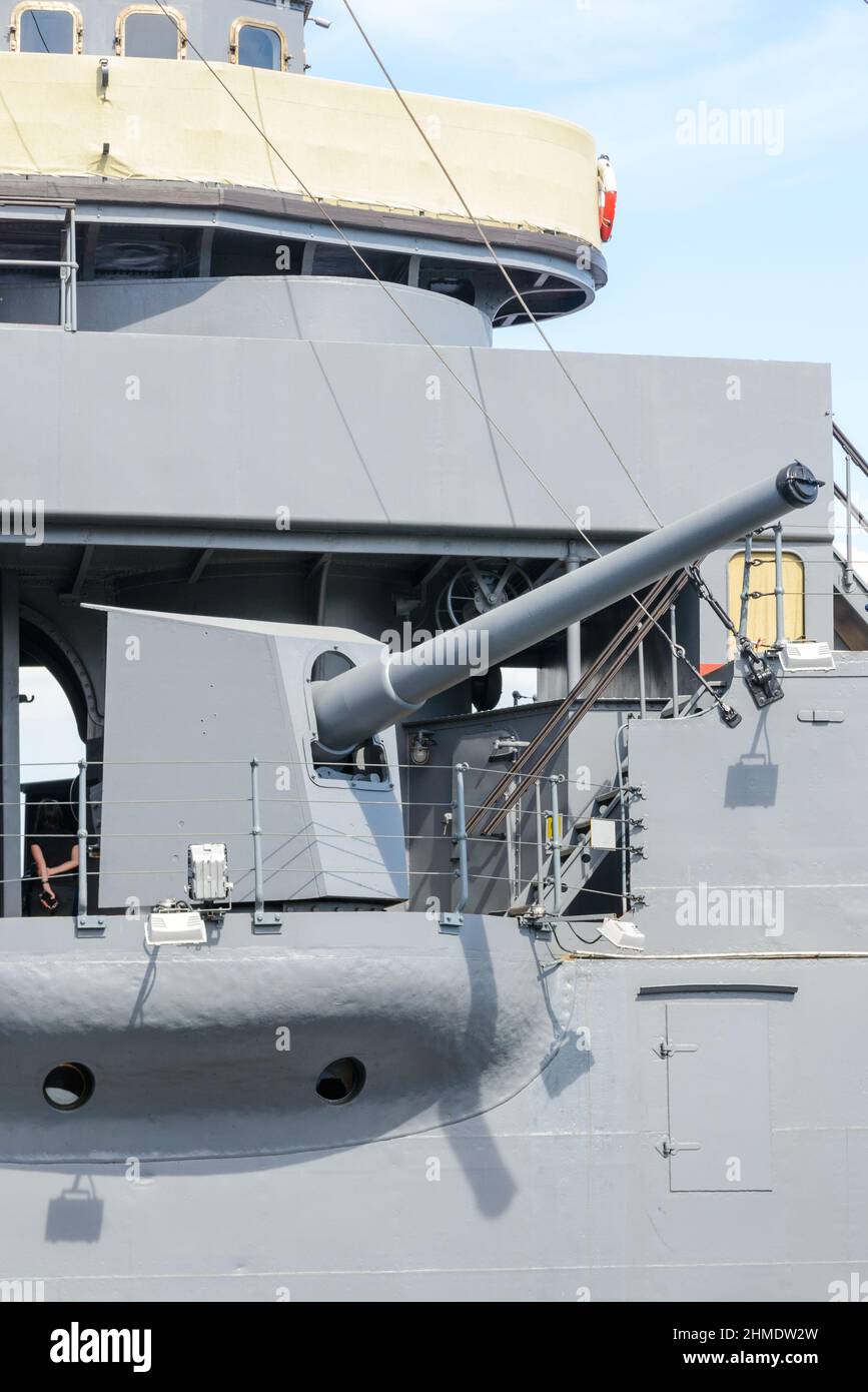 Big gun cannon on right side of warship. Safety boat on a ship Stock ...